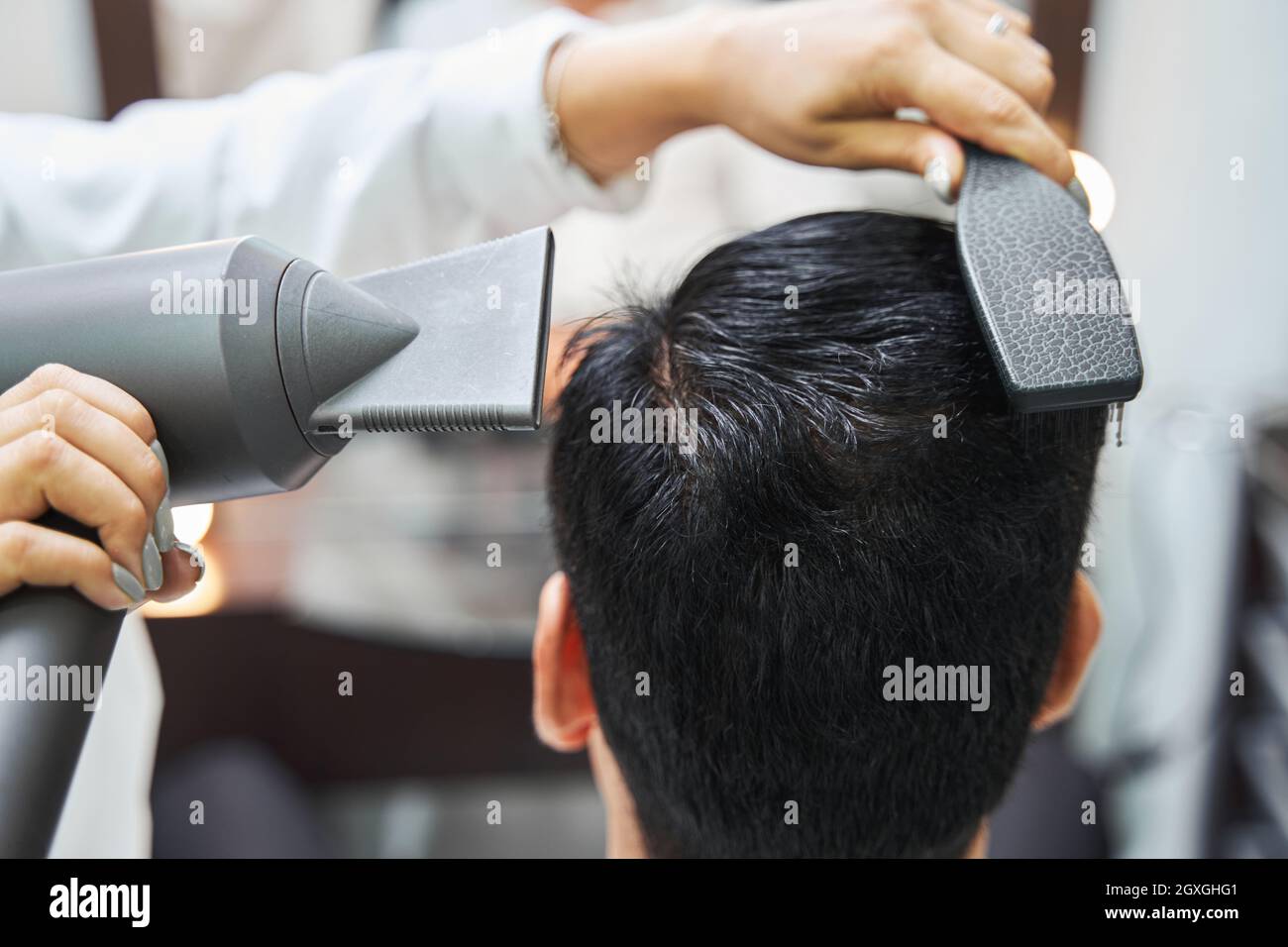 Back of man head being dried by hairdryer Stock Photo - Alamy