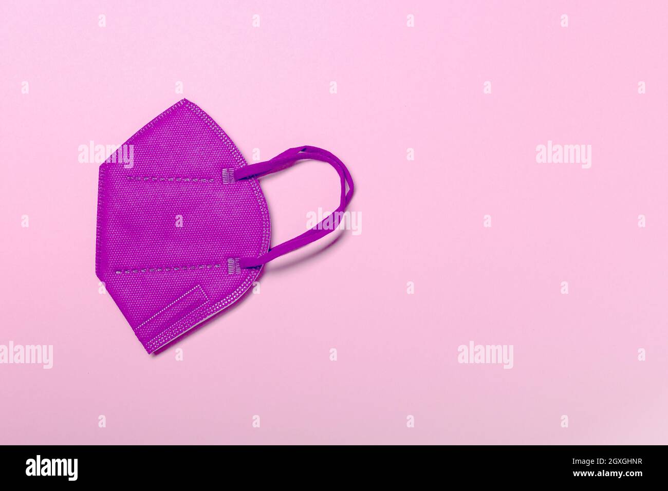 Pink KN95 or N95 FFP2 mask for protection and corona virus on pastel ...