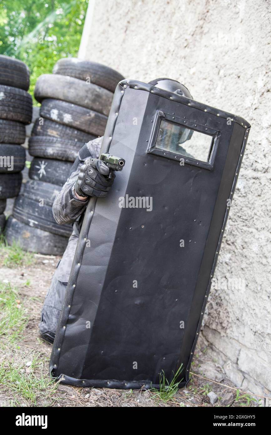 Spec ops police officer SWAT in black uniform in action Stock Photo - Alamy