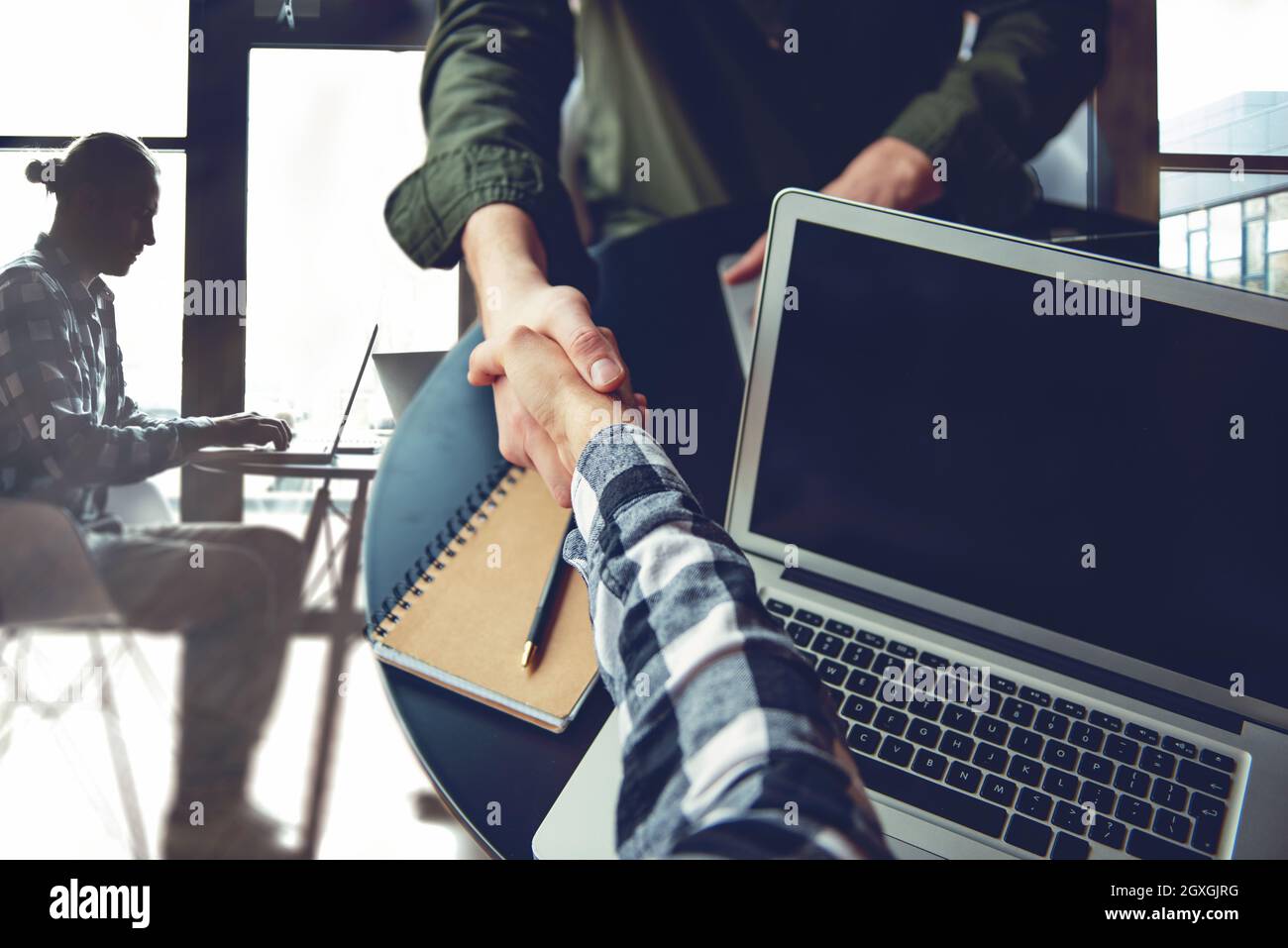 Agreement between young business people with light effects Stock Photo ...