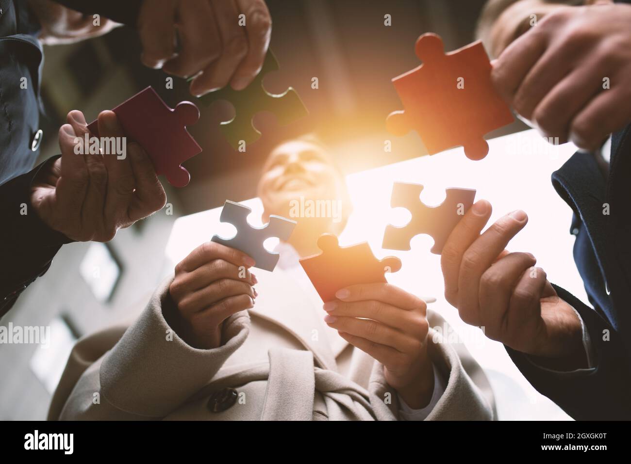 Businessmen working together to build a puzzle. Concept of teamwork ...