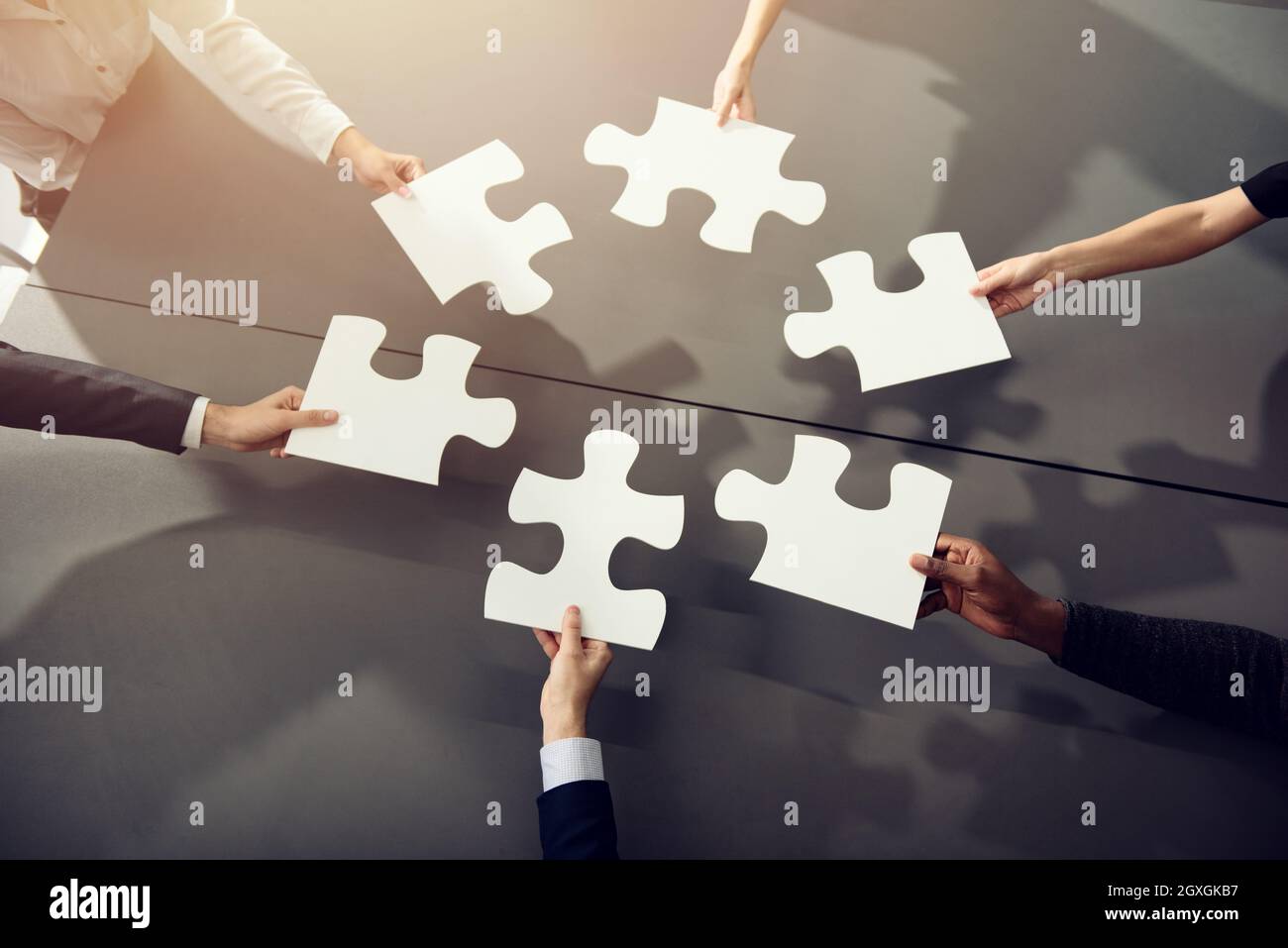 Businessmen working together to build a puzzle. Concept of teamwork, partnership, integration ...