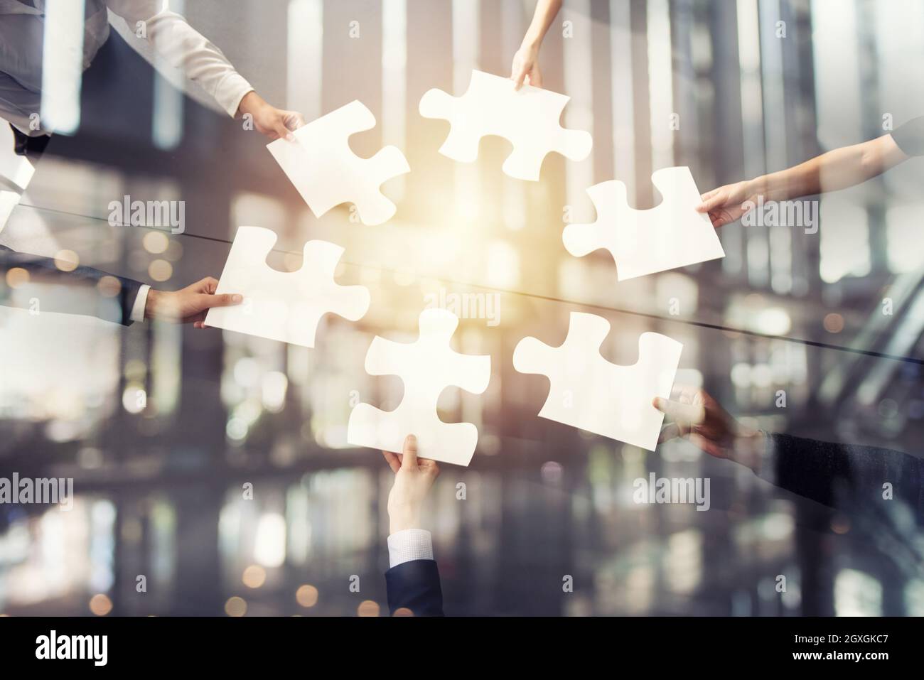 Businessmen working together to build a puzzle. Concept of teamwork, partnership, integration ...