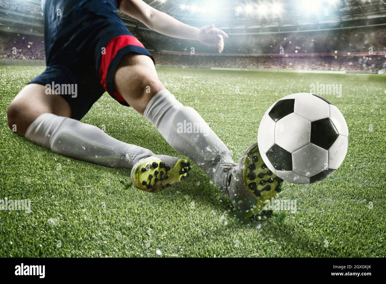 Football action scene with competing football players at the stadium ...