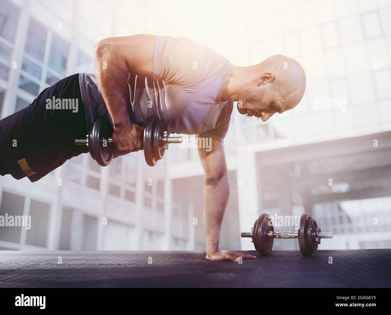 Athletic muscular man training muscles at the gym Stock Photo - Alamy