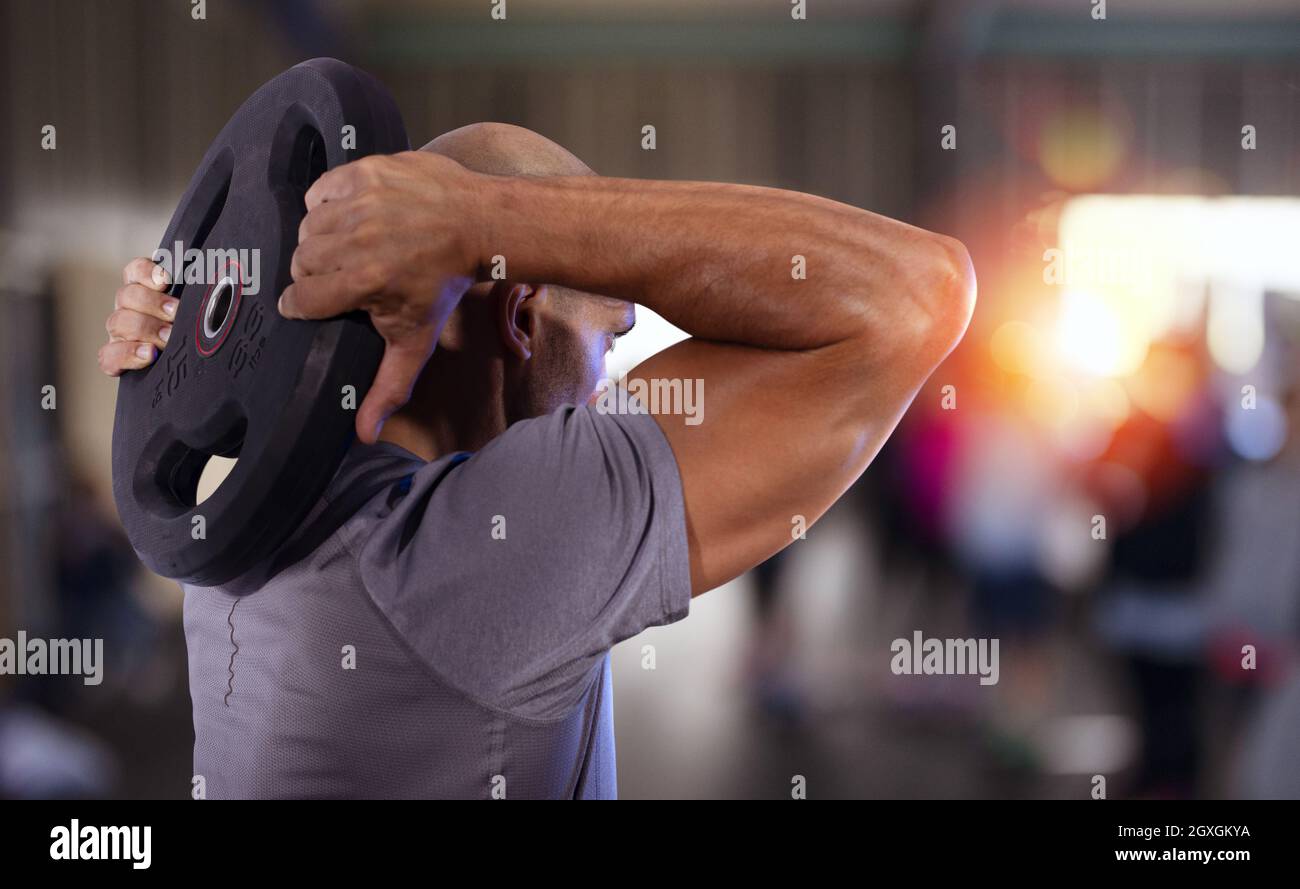 Athletic muscular man training muscles at the gym Stock Photo - Alamy
