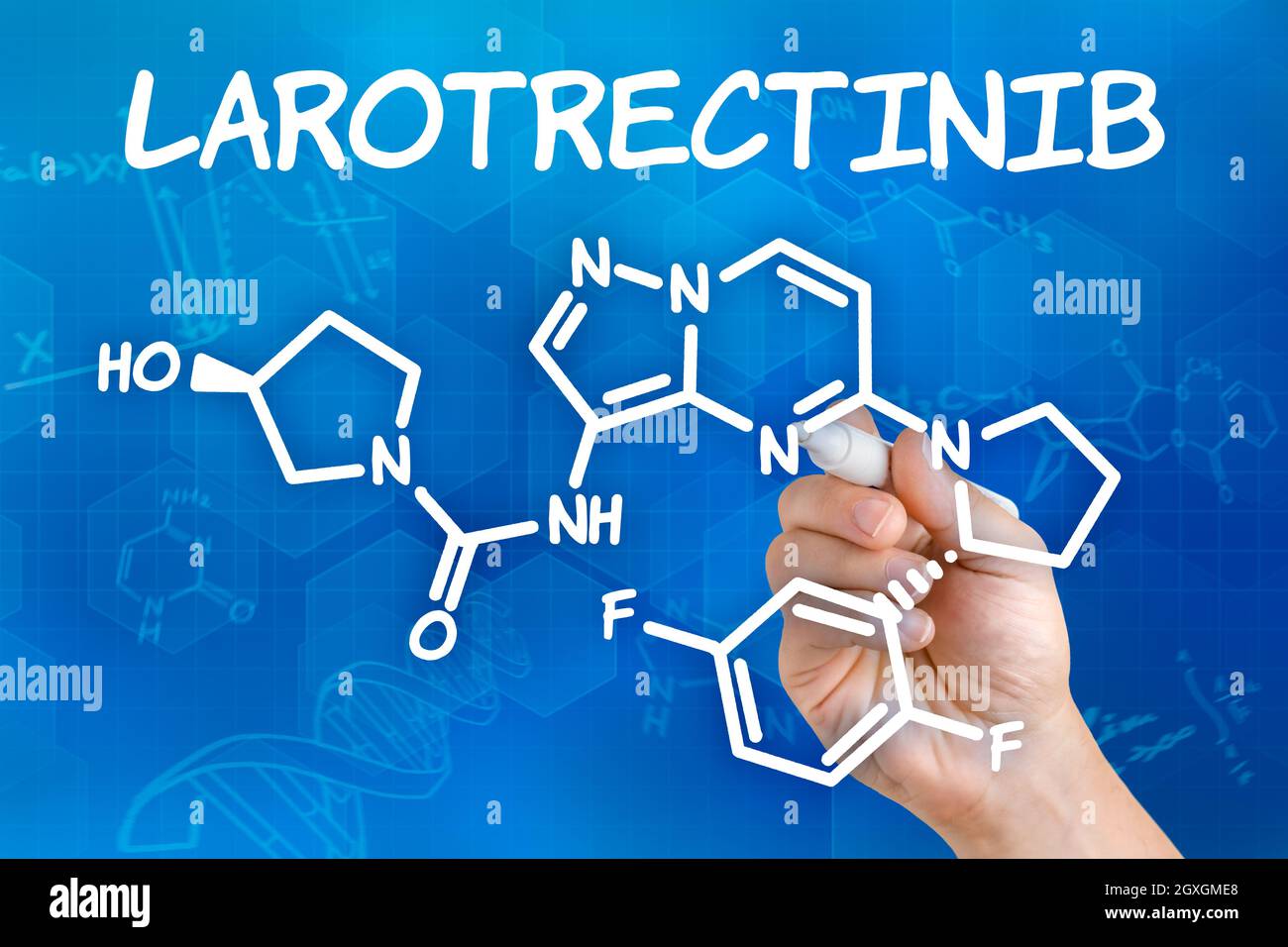 Hand with pen drawing the chemical formula of Larotrectinib Stock Photo ...
