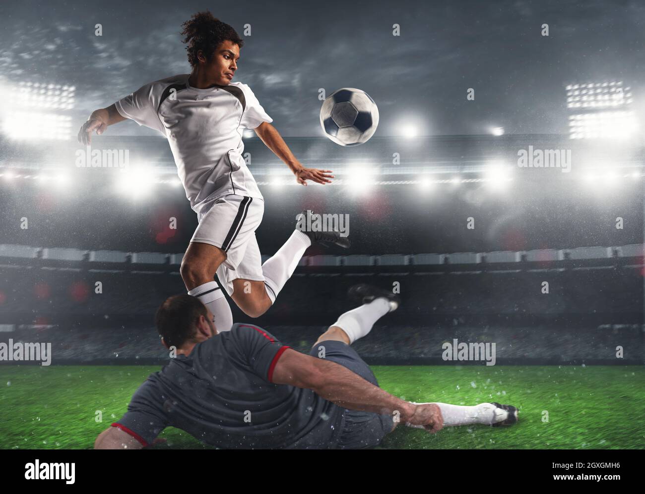 Two soccer players chase the ball at the stadium Stock Photo - Alamy