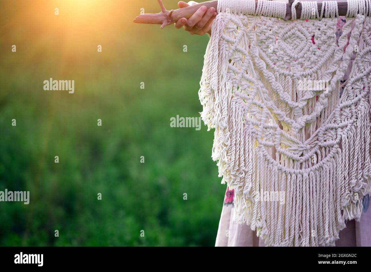creation of a panel from macrame. girl with macram panel in the sunset ...