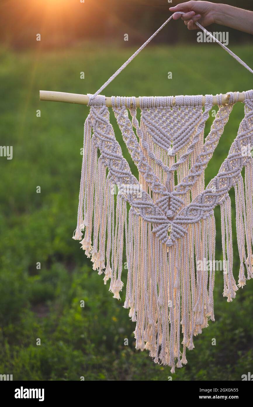 creation of a panel from macrame. girl with macram panel in the sunset ...