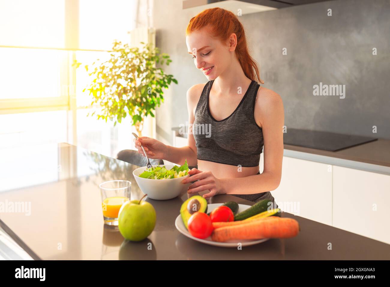 Girl with athletic physique takes care of fitness eating a salad Stock ...