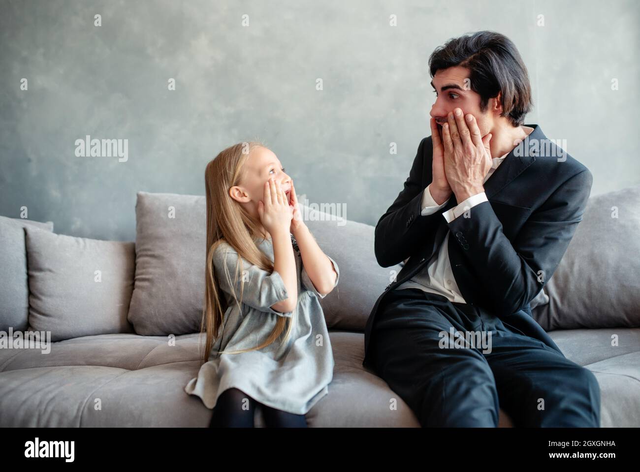 Father and daughter look shocked something at home Stock Photo - Alamy