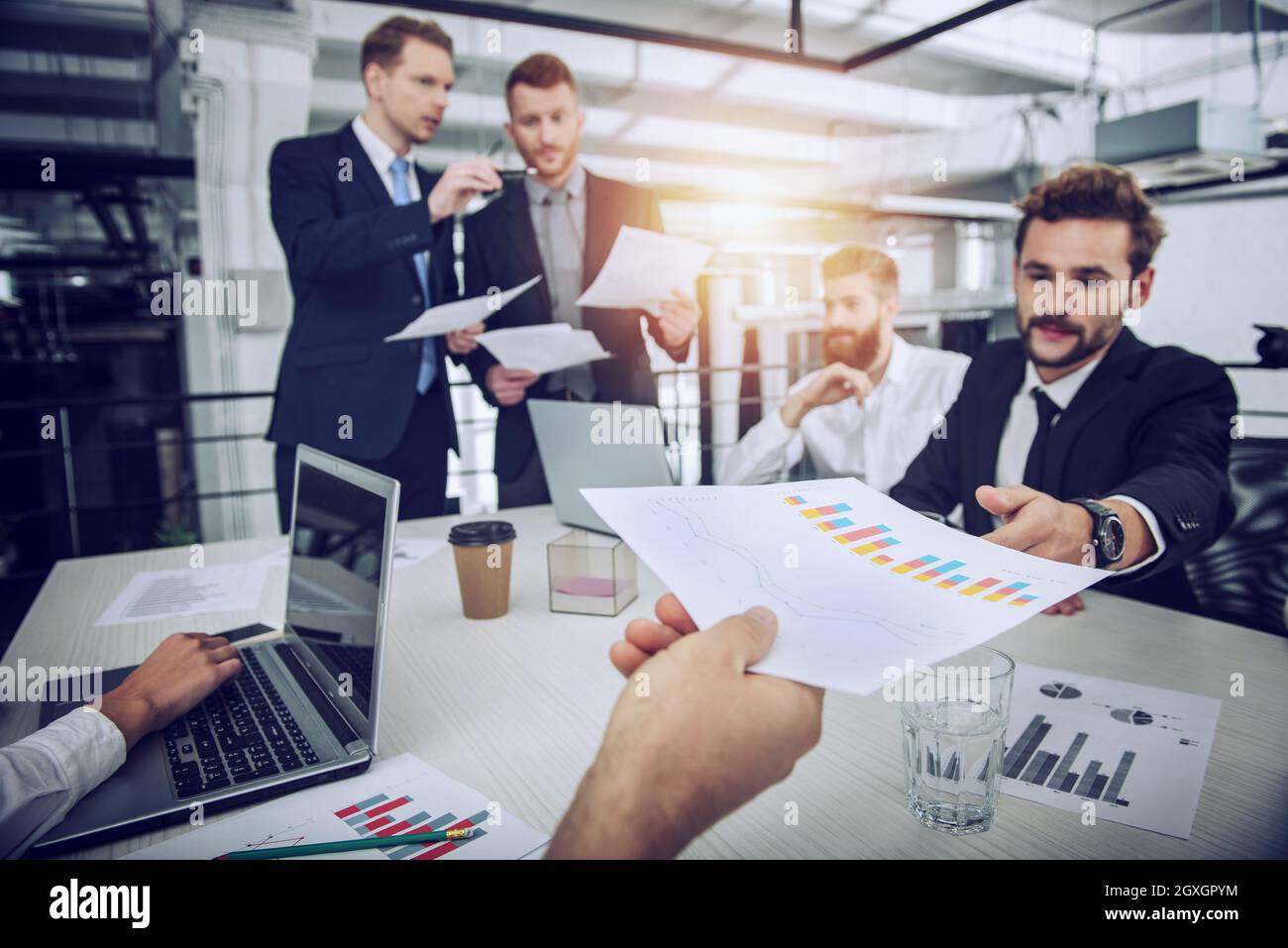 Team of people work together on company statistics in office. concept ...