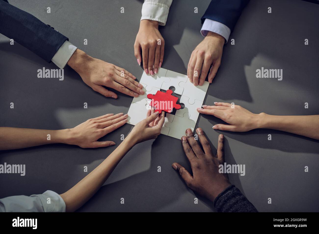 Businessmen working together to build a puzzle. Concept of teamwork, partnership, integration ...