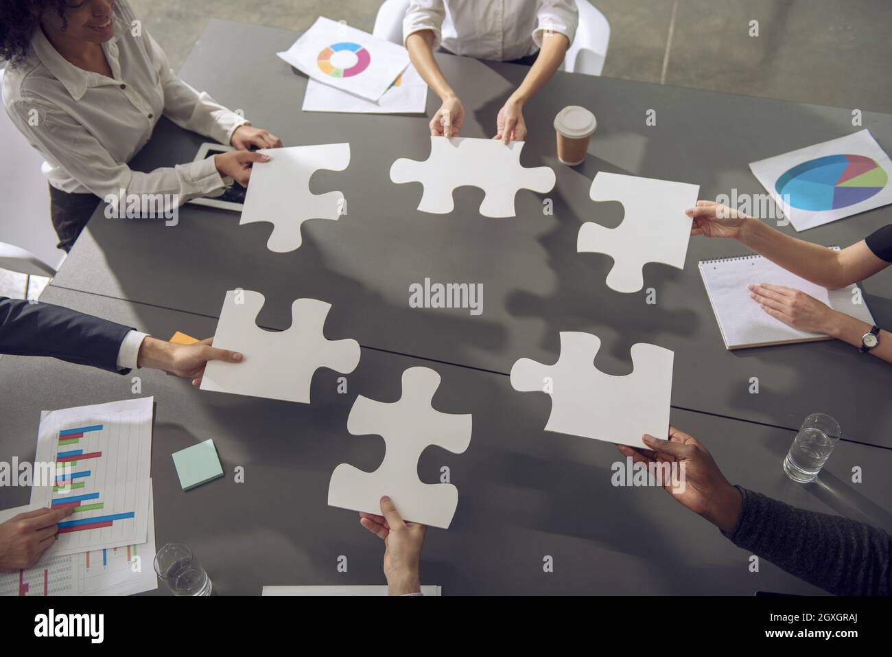 Businessmen working together to build a puzzle. Concept of teamwork, partnership, integration ...