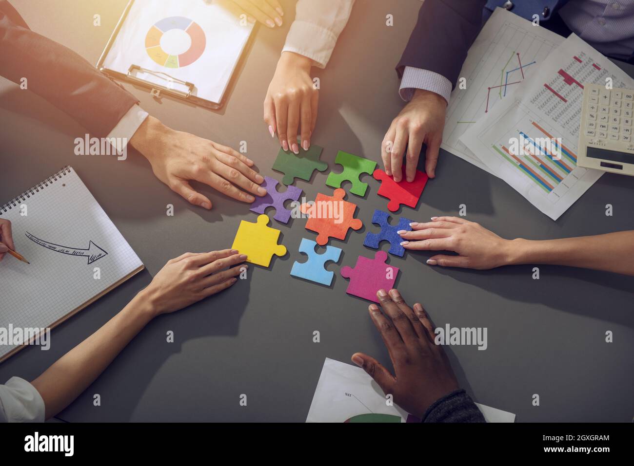 Businessmen working together to build a puzzle. Concept of teamwork, partnership, integration ...