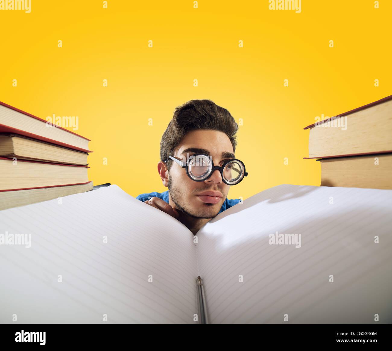 Young Exhausted Student is studying hard on the desk Stock Photo - Alamy