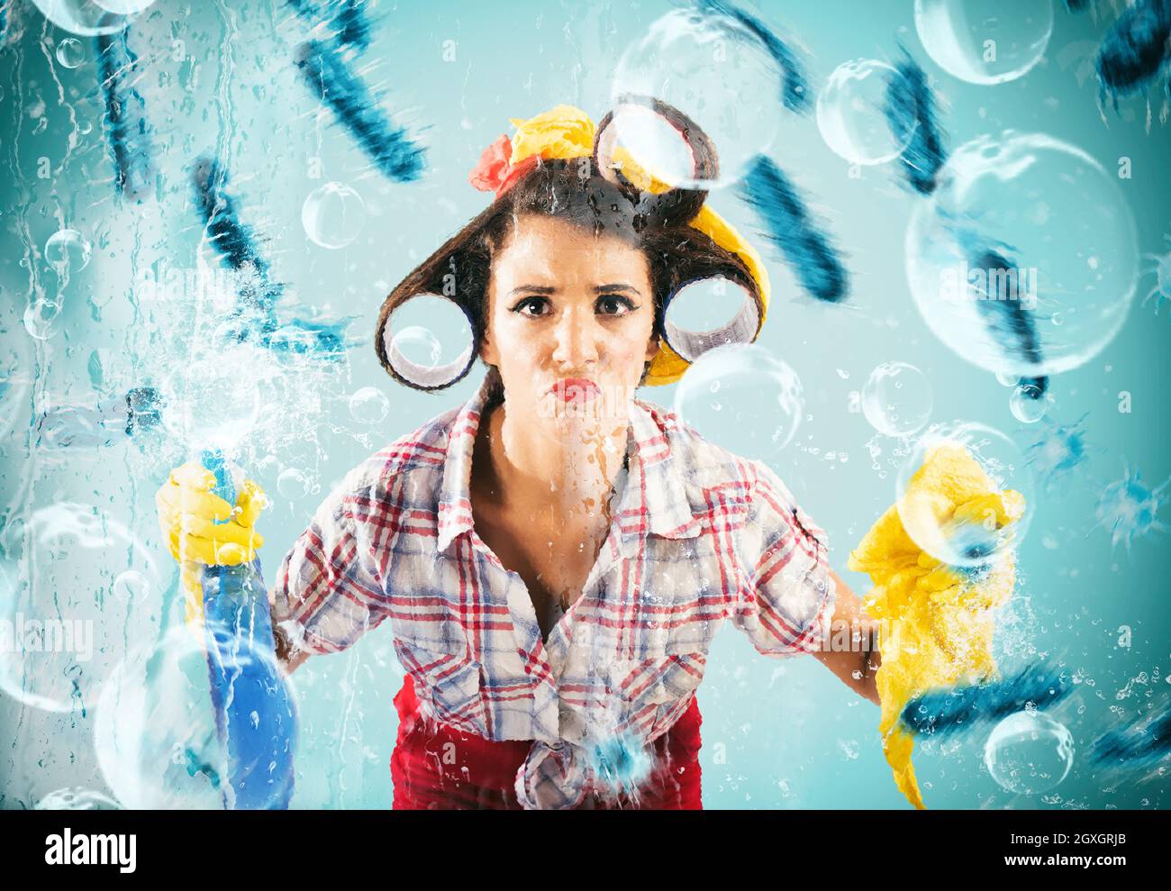 Funny housewife busy in household cleaning with spray disinfectant ...