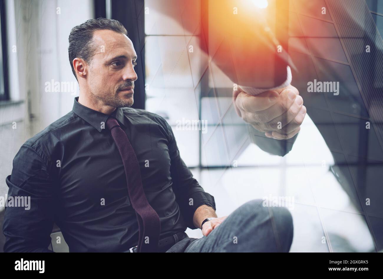 Confident businessman during a meeting in office. He watches far for ...