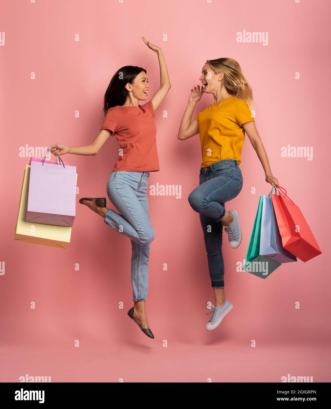 Two cute girls are happy after shopping. Joyful expression. Shop ...