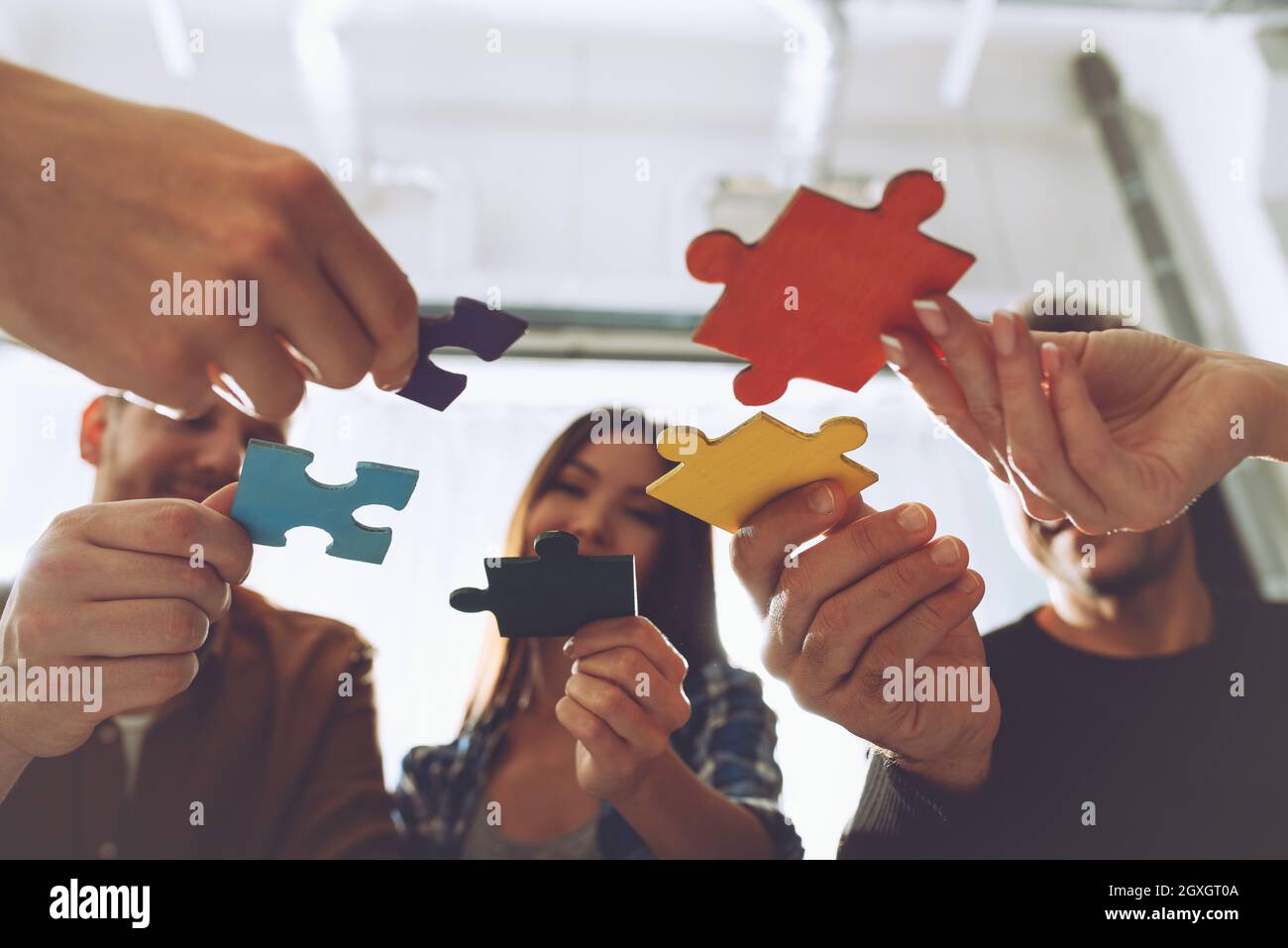 Businessmen working together to build a puzzle. Concept of teamwork ...