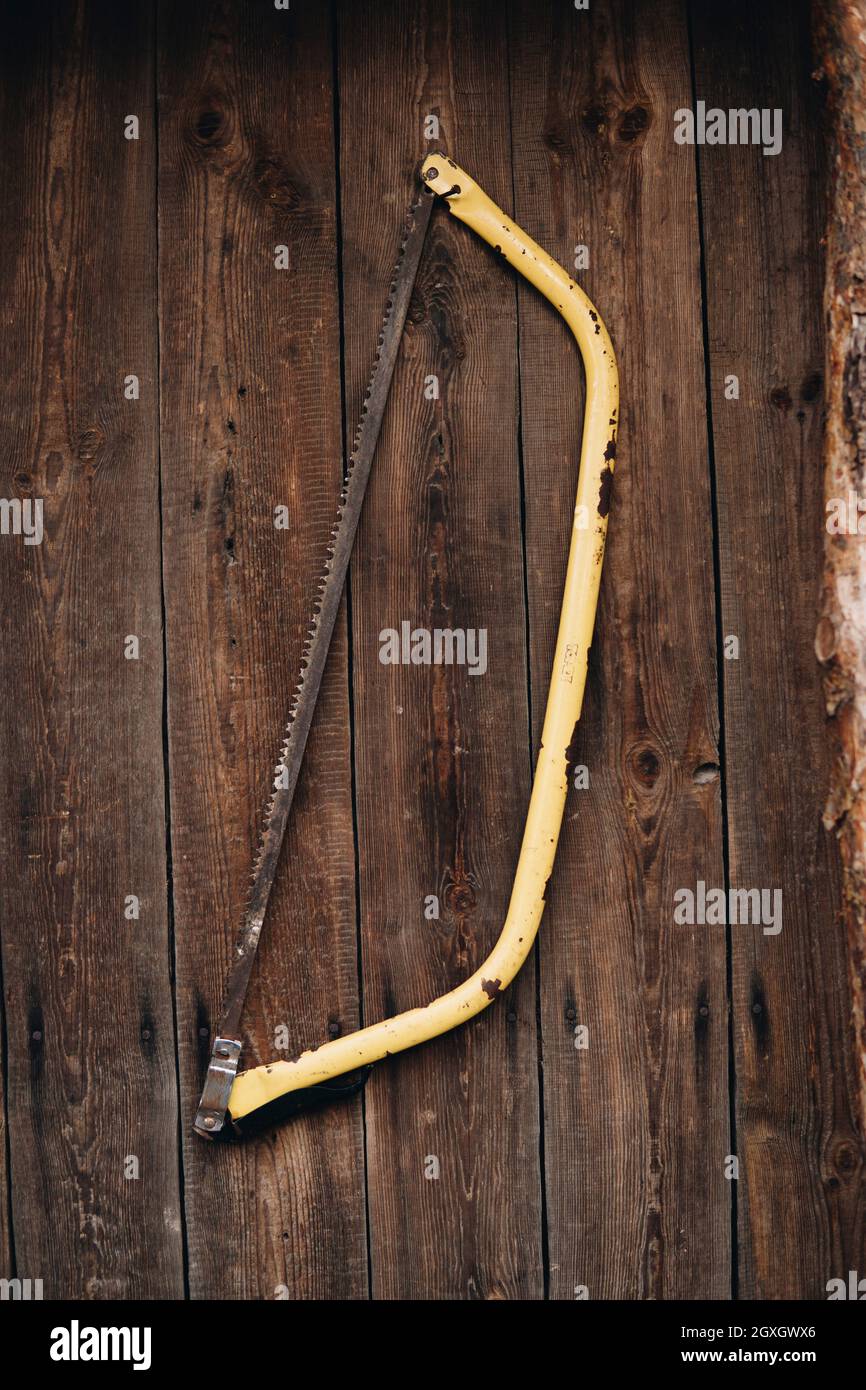 detail of old metal saw hanging in front of wooden wall Stock Photo - Alamy