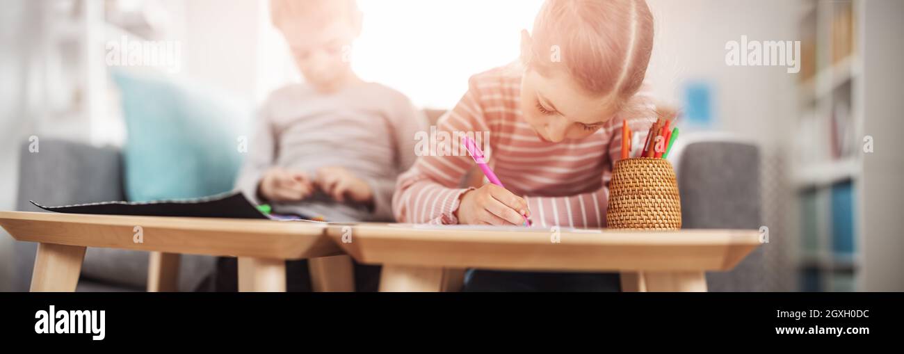 Children playing together with modeling clay and drawing by pencils ...