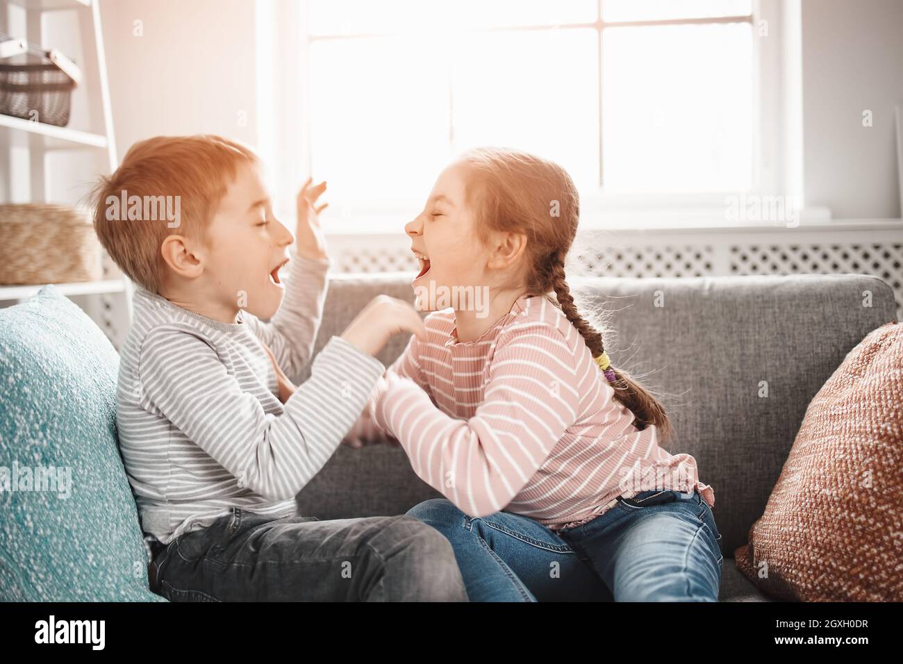 Two little kids having fight at home. Concept of the family ...