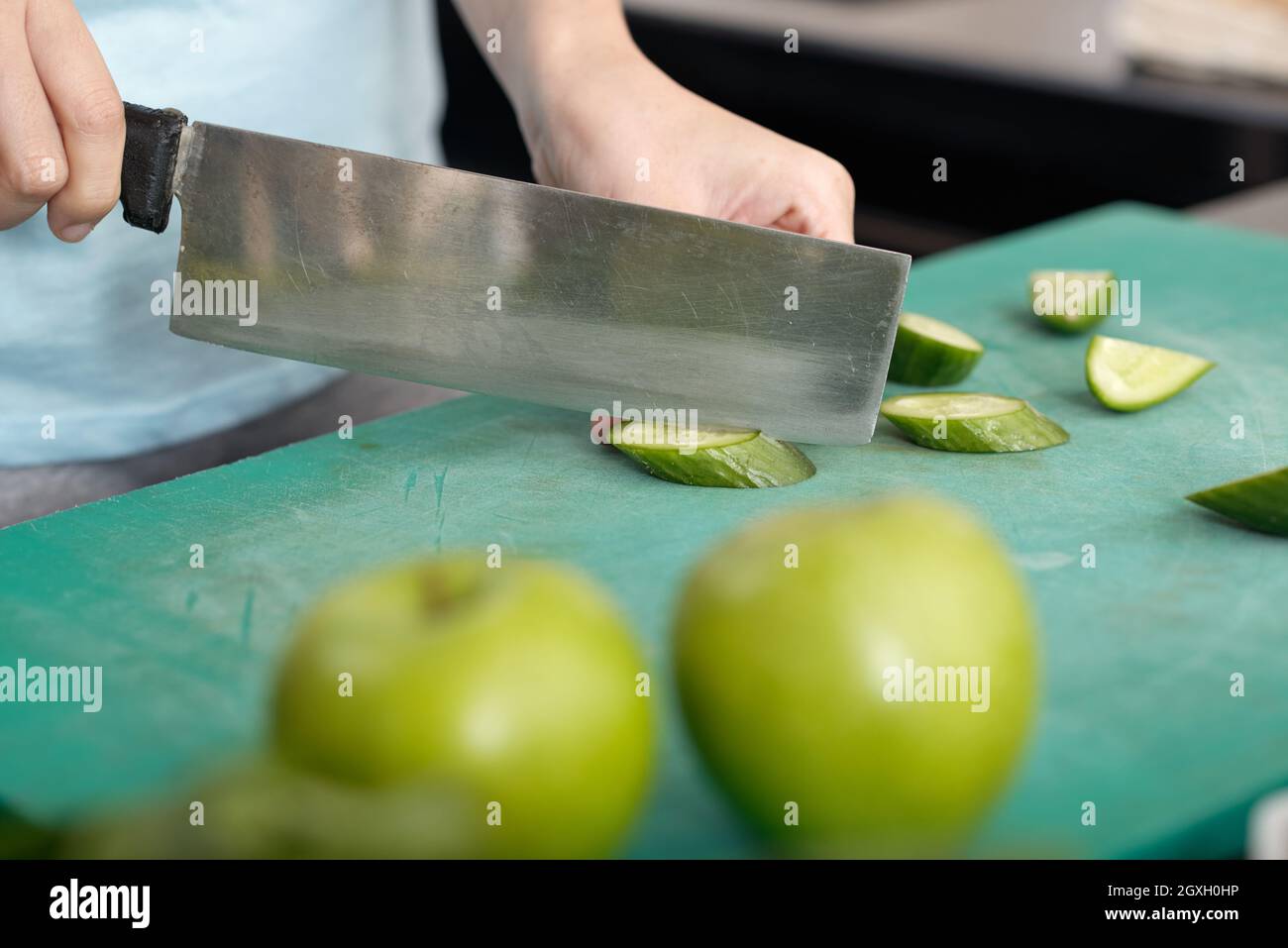 Close-up of unrecognizable woman using vegetable knife while cutting ... Close-up of unrecognizable woman using vegetable knife while cutting ...