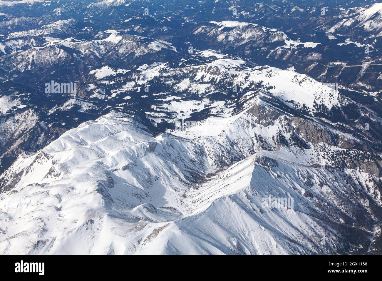 Aerial view of mountains covered by snow . Scenery of Alps in the ...