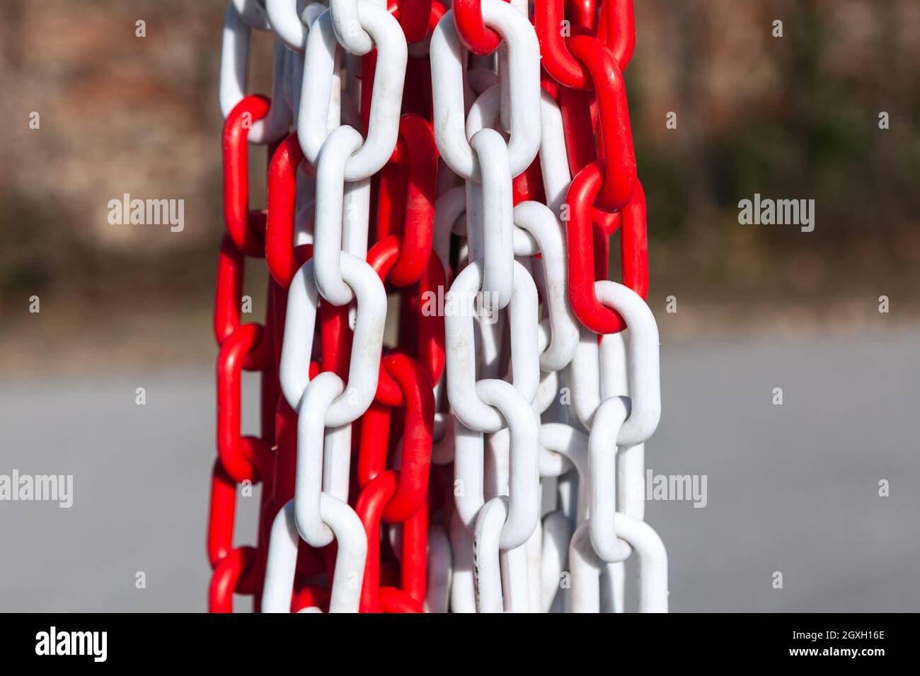 Red and white chains . Oval polyethylene signal chain Stock Photo - Alamy