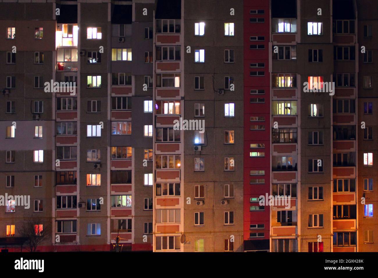 Lighted windows in nocturnal high-rise building. Illuminated windows in ...