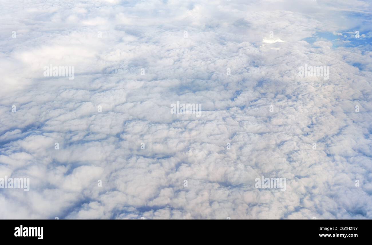 Fluffy clouds that looks as flat surface as seen from commercial ...