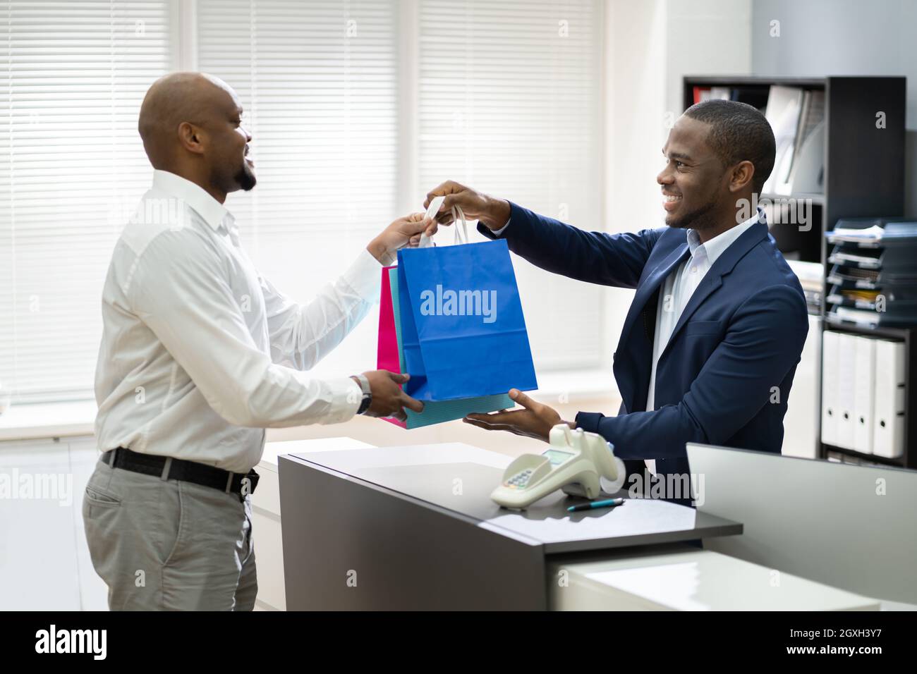 Cashier In Retail Shop Or Store At Counter Stock Photo - Alamy