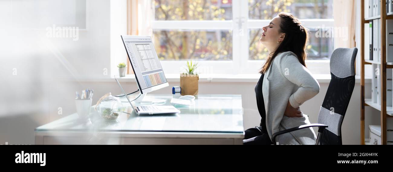 Bad Posture Sitting In Office With Backache In Chair Stock Photo - Alamy