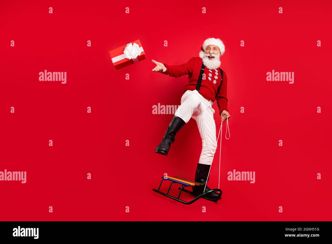 Full length body size view of carefree cheerful Santa throwing gift ...