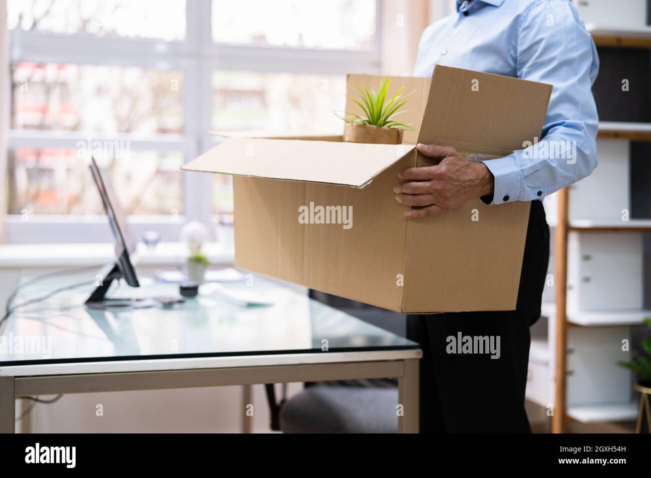 Job Quit. Employee Holding Cardboard Box At Desk Stock Photo - Alamy