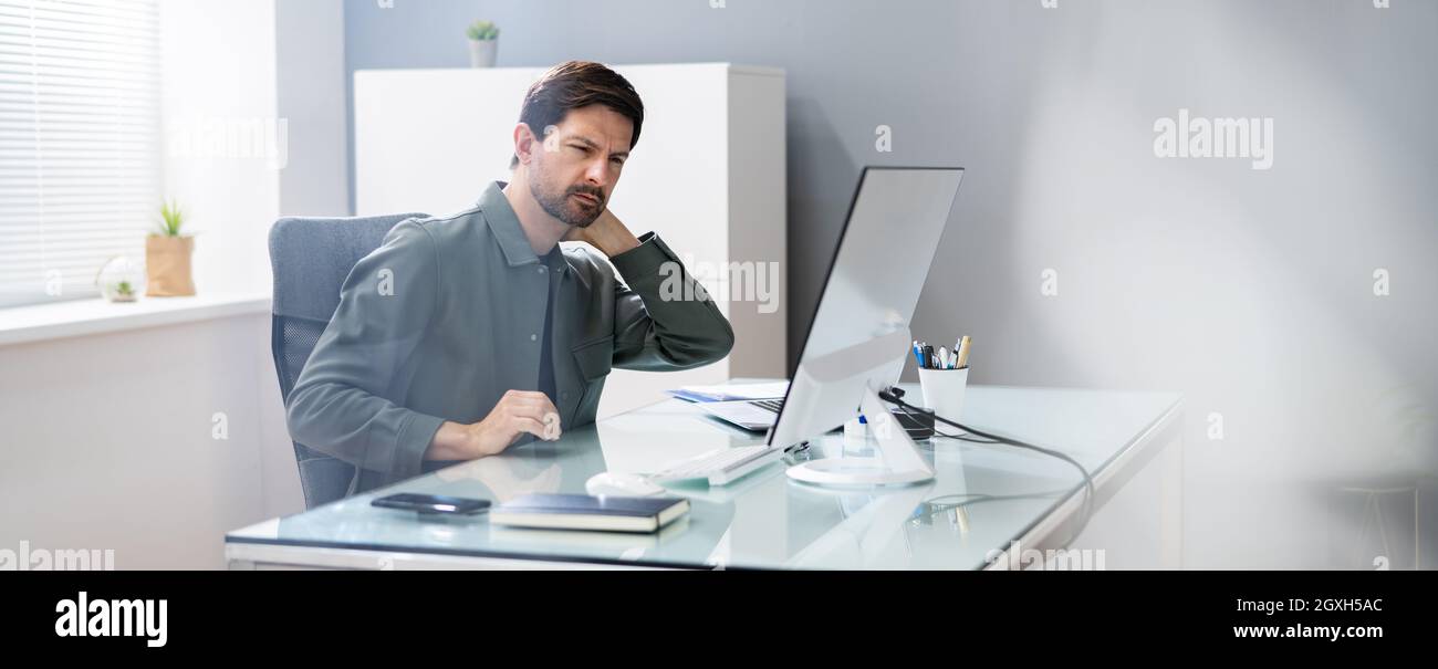 Neck Pain And Stress. Bad Posture At Computer In Office Stock Photo - Alamy