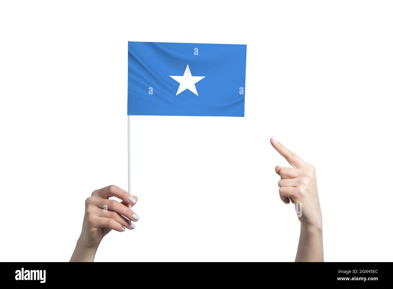 A beautiful female hand holds a Somalia flag to which she shows the ...