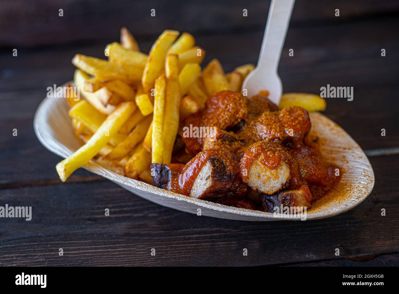 Traditional german Currywurst or curry sausage with french fries served ...
