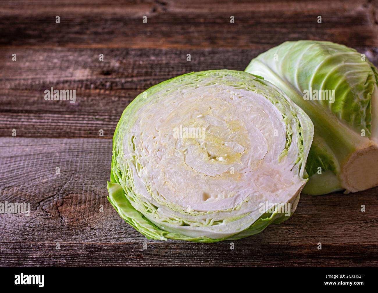 Halved cabbage isolated on wooden background with copy space Stock ...