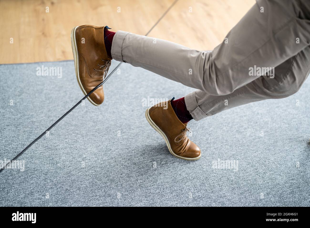 Wire Cord Trip Over And Fall. Feet Stumble On Cable Stock Photo - Alamy