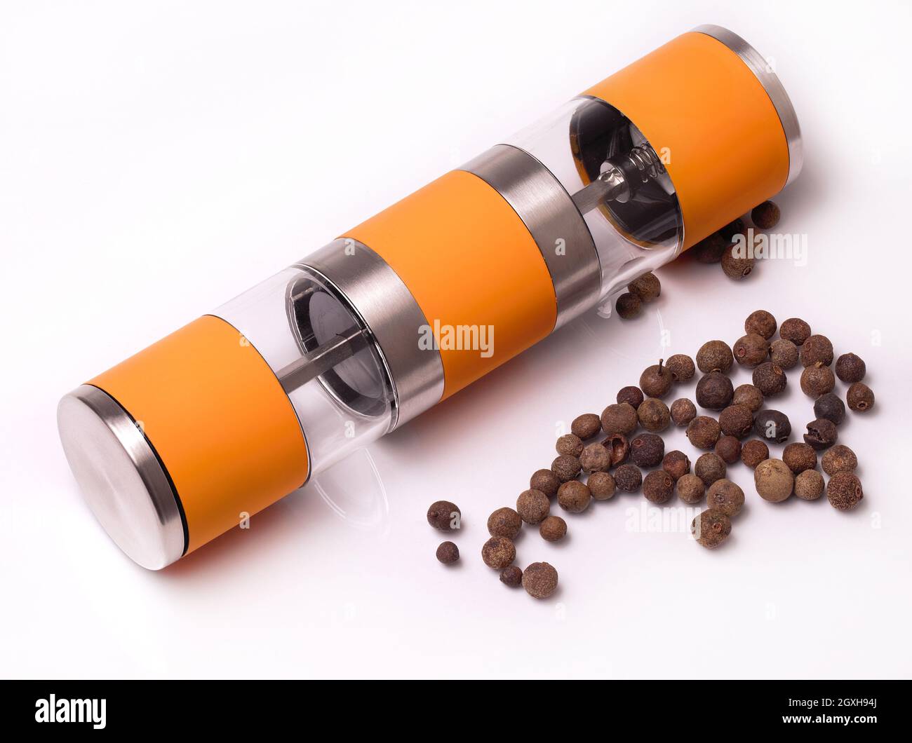 manual pepperbox and spilled pepper on the white background Stock Photo ...