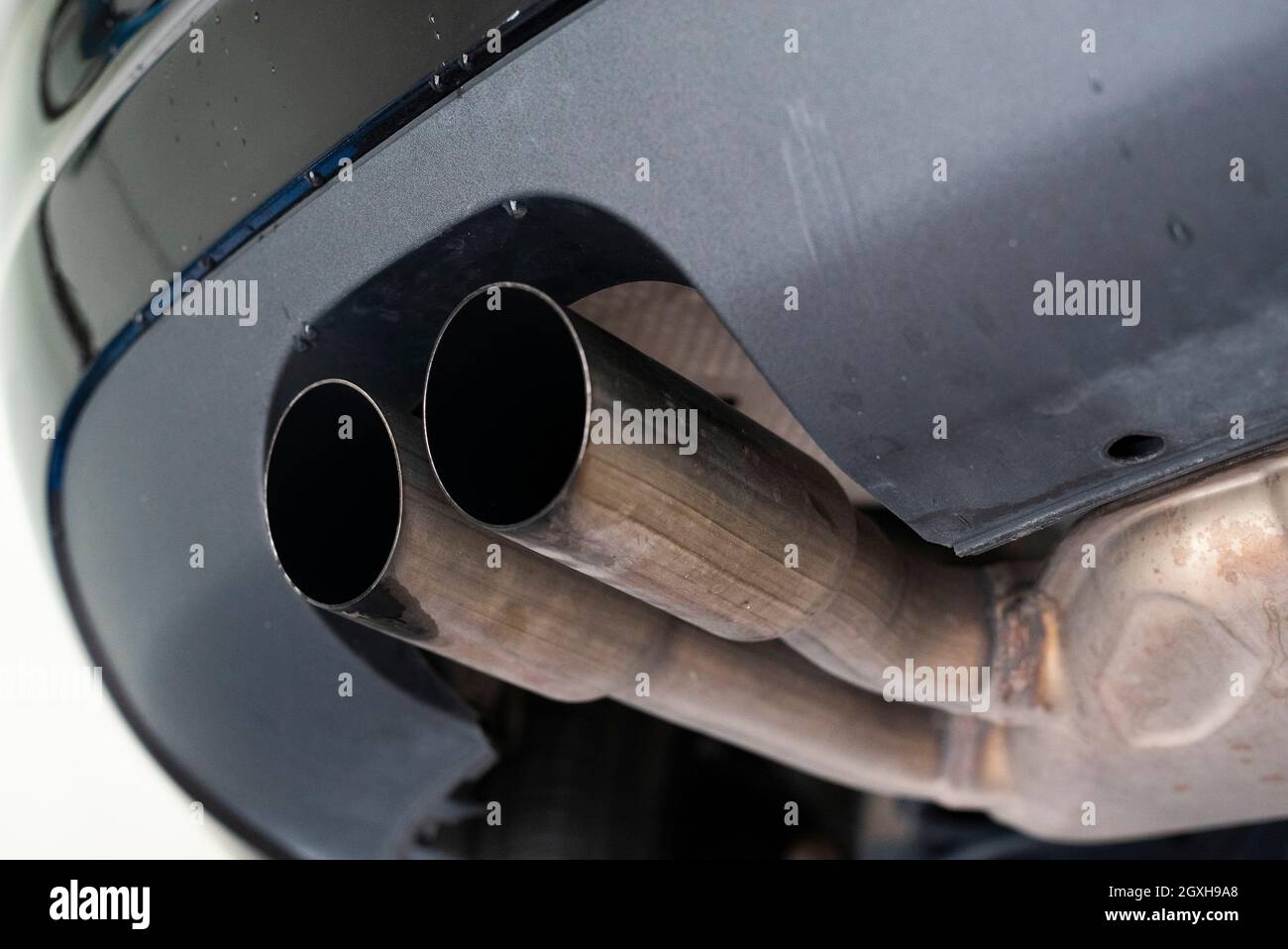 Modern Car exhaust detail taken from below Stock Photo - Alamy