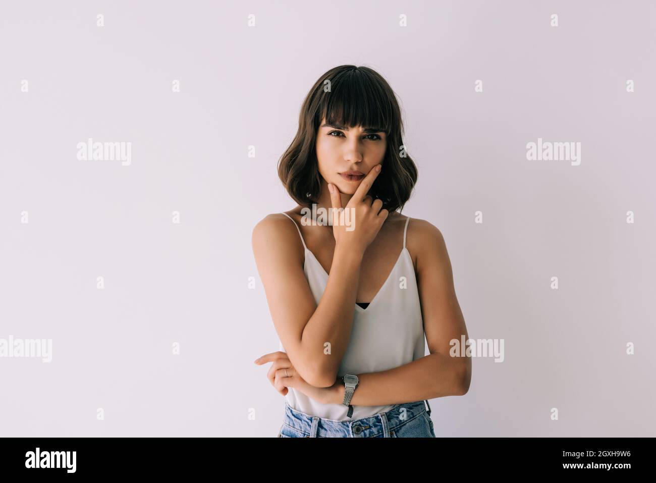 Happy woman thinking and looking sideways isolated on a white ...
