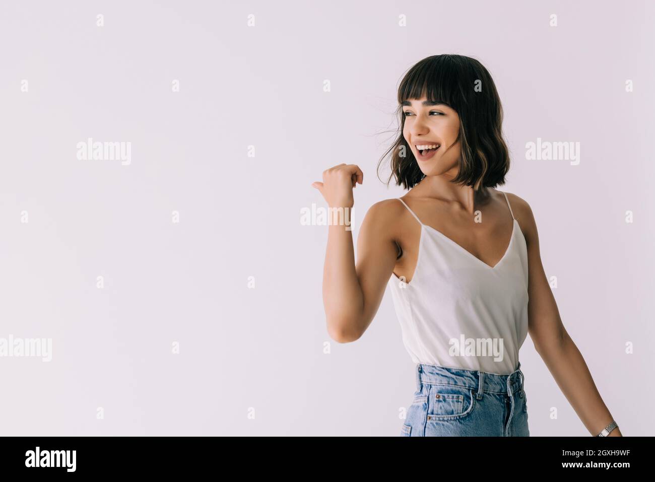 Portrait brunette woman pointing behind hi-res stock photography and ...