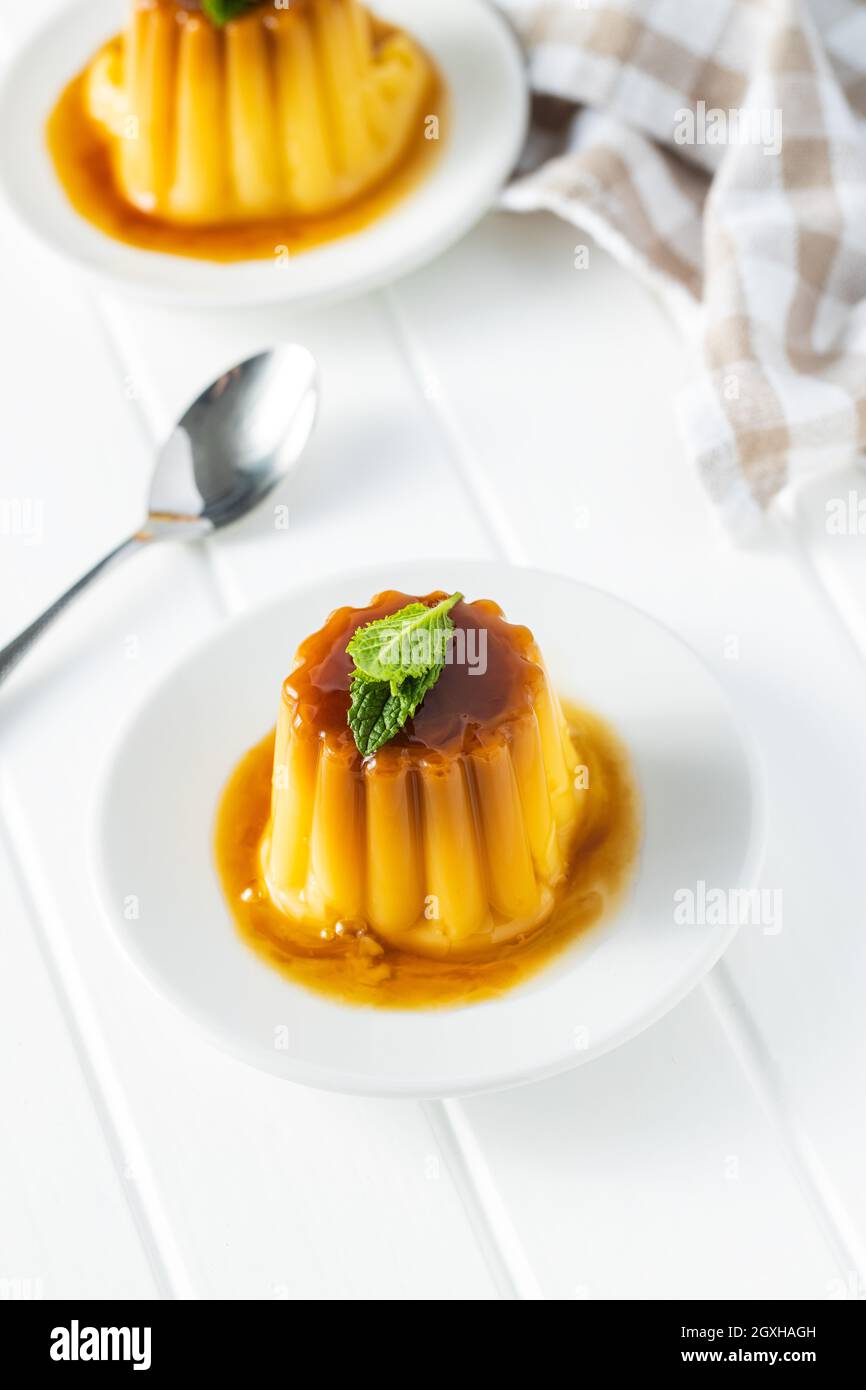 Sweet vanilla pudding. Sweet dessert with caramel topping on white ...