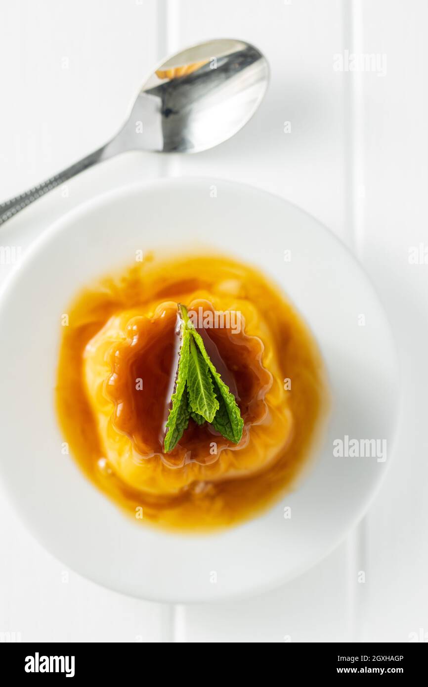 Sweet vanilla pudding. Sweet dessert with caramel topping on white ...