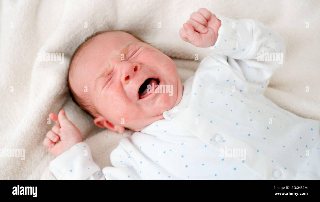 Baby lying in crib crying hi-res stock photography and images - Alamy