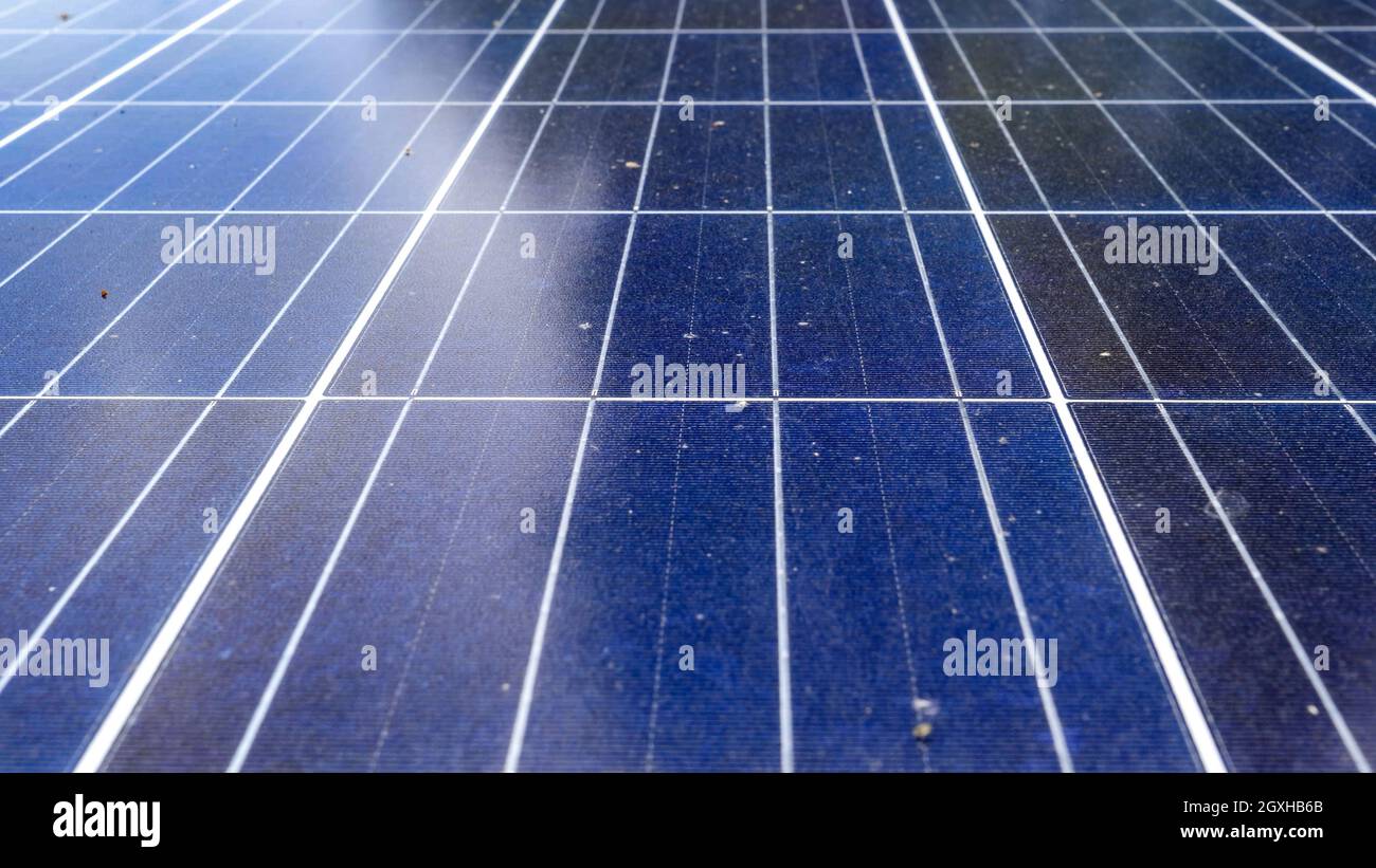 dirty and covered with dust solar energy panels installed on house roof ...